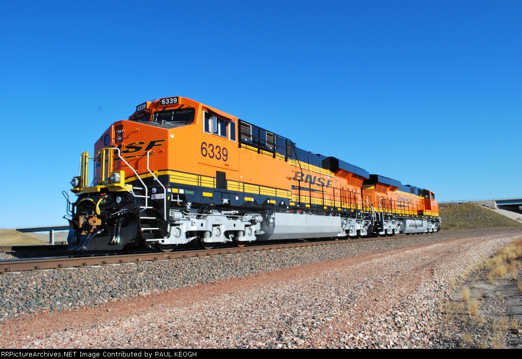 The Awesome Twosome BNSF 6339 and BNSF 6337 Helper unit consist wait to push a loaded coal south ...
